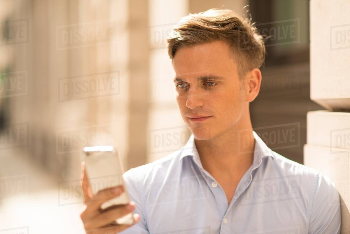 Man texting in street, close up - Royalty-free Stock Photo | Dissolve