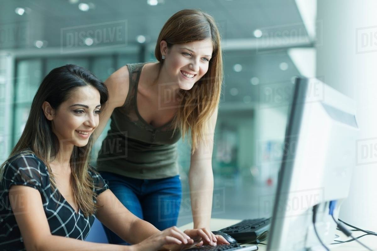 Women using computer in the library - Royalty-free Stock Photo | Dissolve