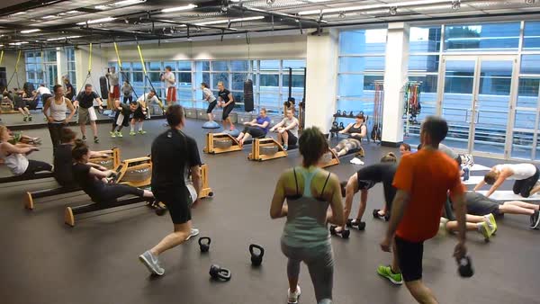 Many people exercising during a group workout together at gym. - Stock ...
