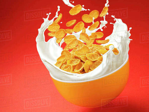Corn flakes with milk splashes on red background, healthy cereal ...