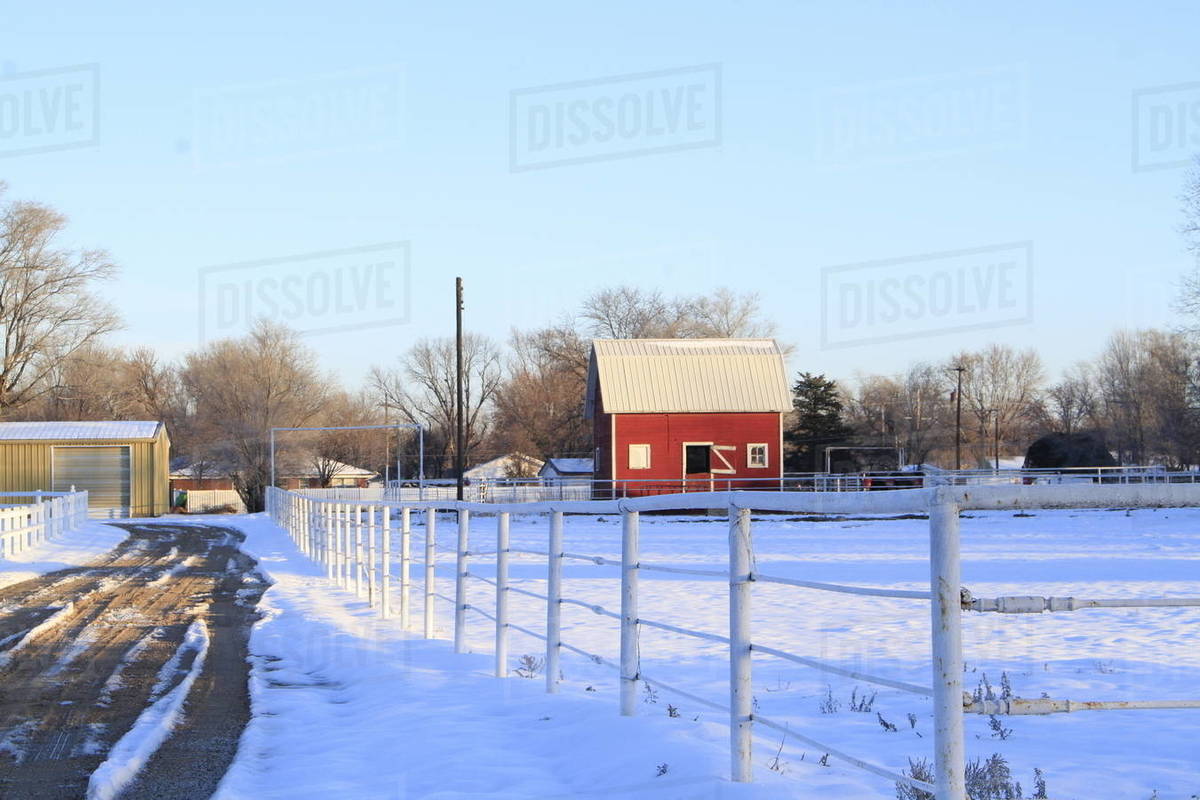 Kansas Snowy winter with a Red Barn and Snow with a fence that was in ...
