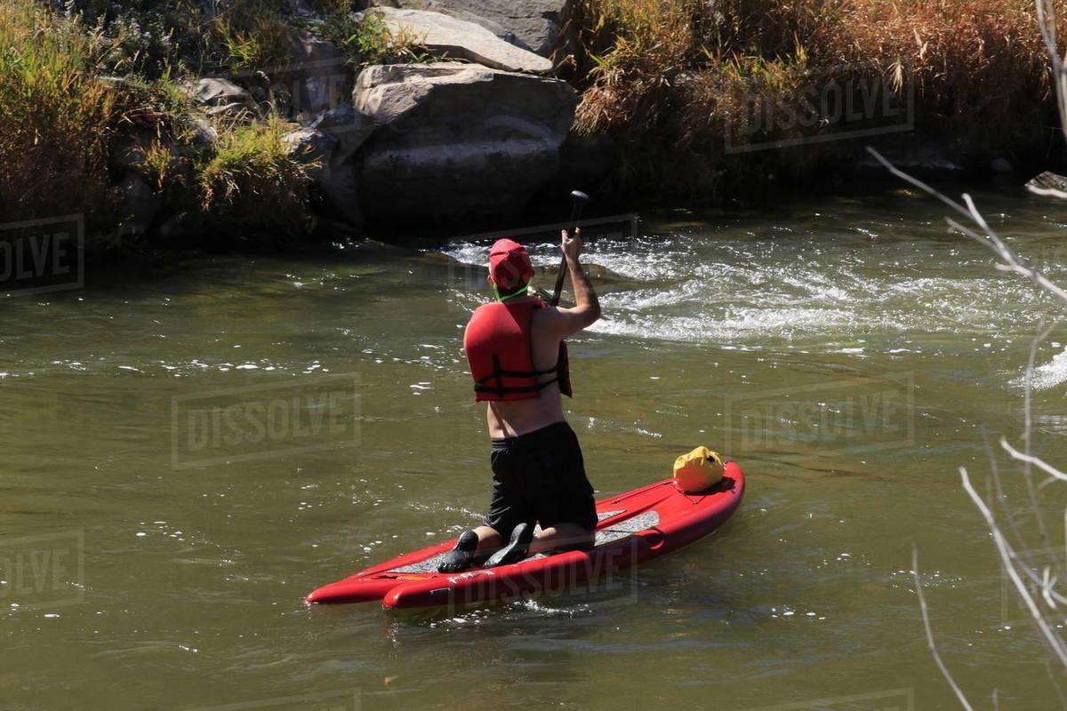 Man Paddle Boarding on Weber River by Devil Slide in Utah,., - Royalty-free Stock Photo | Dissolve