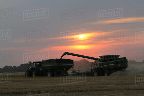 Kansas Wheat Harvest at Sunset with a John Deere Combine, Tractor and ...