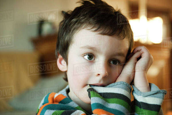 Little boy daydreaming, chewing distractedly on shirt sleeve - Royalty ...