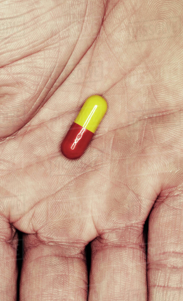 Capsule in palm of man's hand - Royalty-free Stock Photo | Dissolve