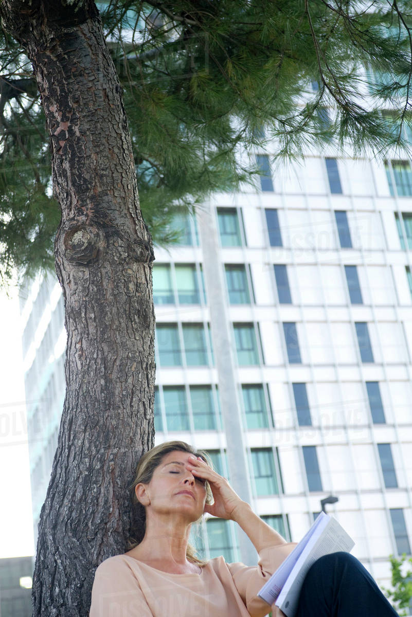 Woman resting under tree with eyes closed - Royalty-free Stock Photo ...