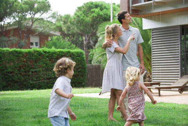 Family relaxing together in backyard - Royalty-free Stock Photo | Dissolve