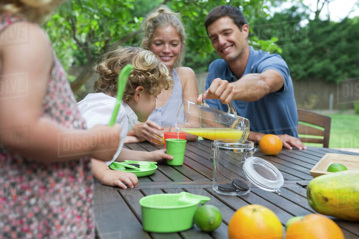 Family enjoying outdoor snack - Stock Photo - Dissolve