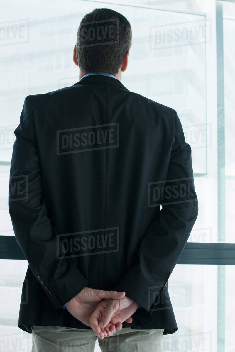 Executive looking out window, rear view - Royalty-free Stock Photo ...