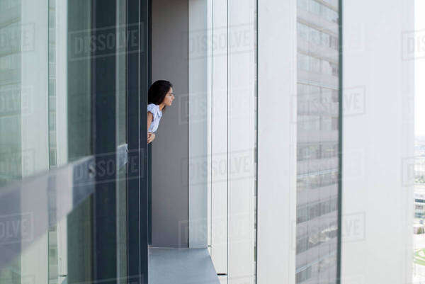 Woman leaning out of window looking at view - Royalty-free Stock Photo ...