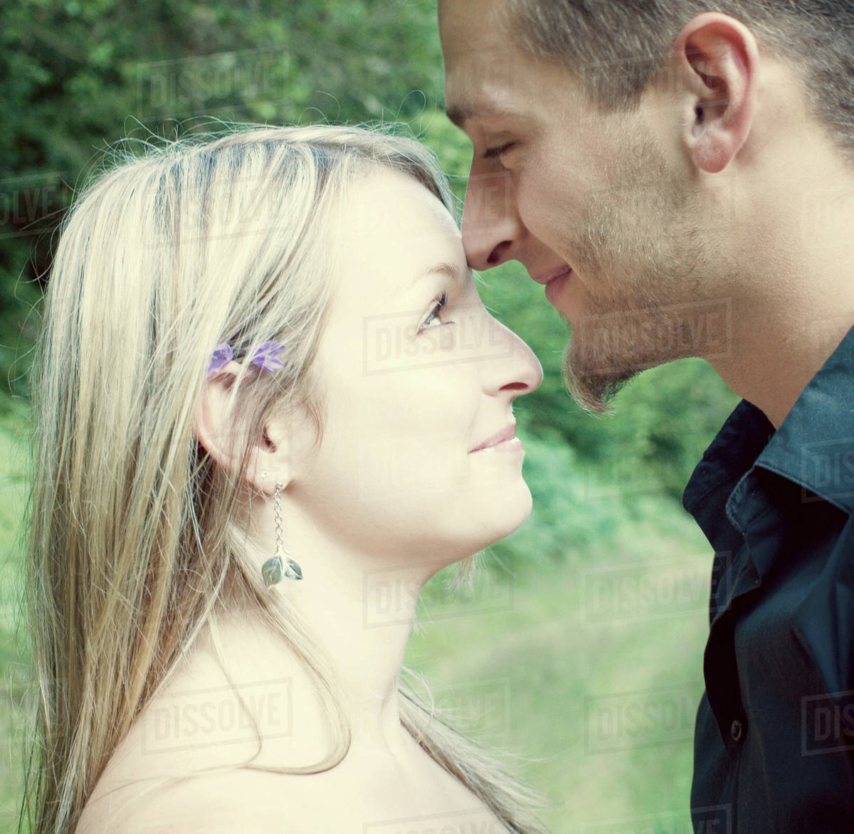 Couple nuzzling outdoors - Royalty-free Stock Photo | Dissolve