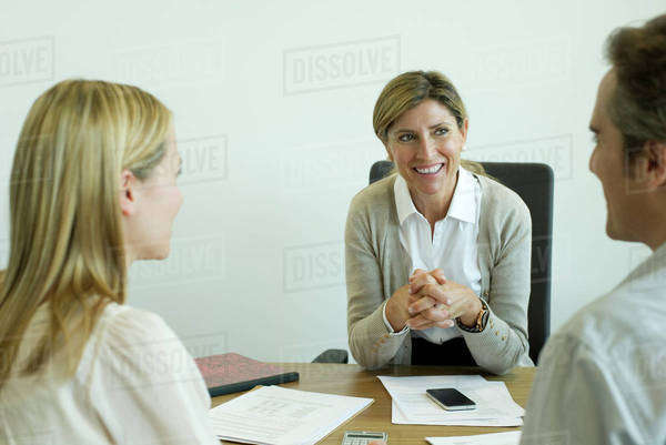 Businesswoman talking with clients in office - Royalty-free Stock Photo ...