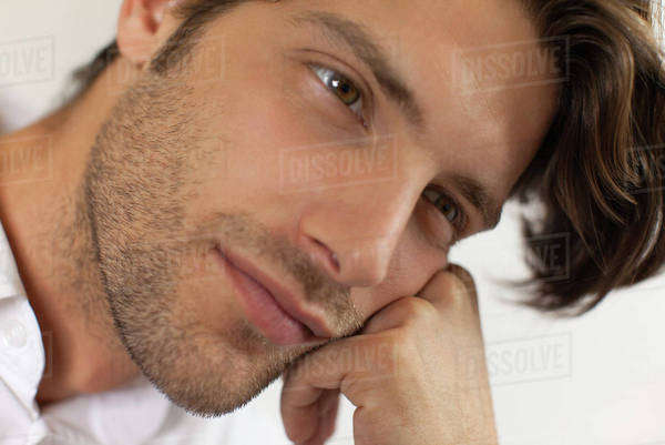 Man resting head on hand, daydreaming - Royalty-free Stock Photo | Dissolve