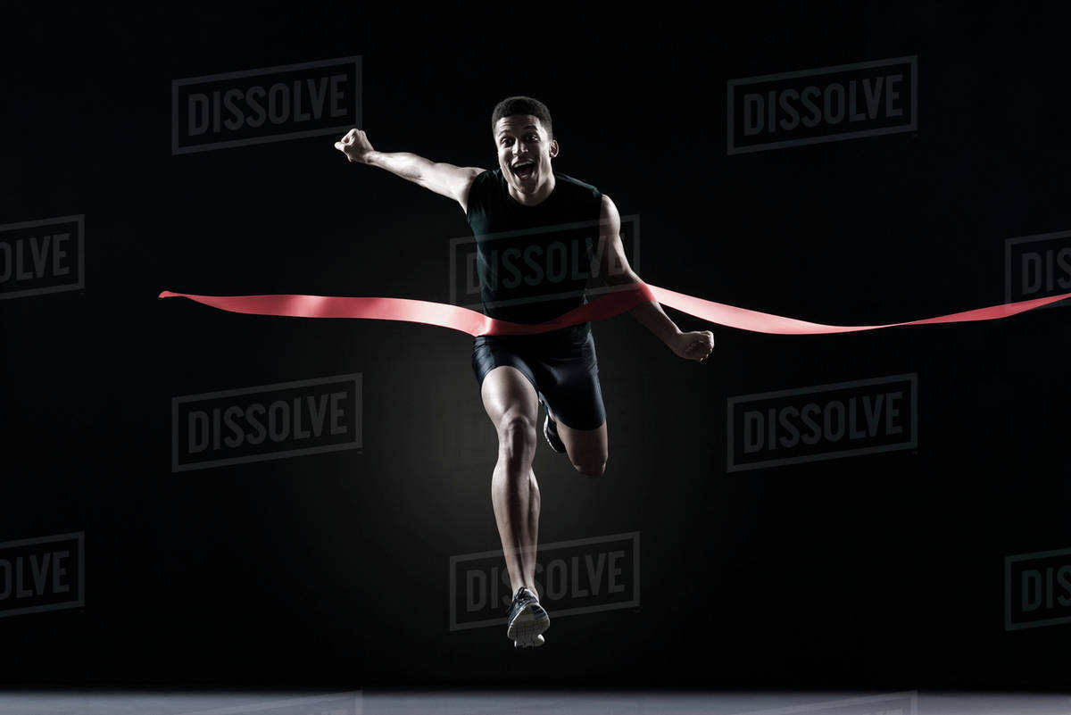 Runner crossing finish line - Royalty-free Stock Photo | Dissolve