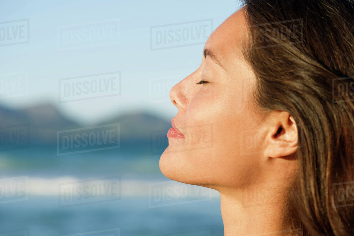 Young woman with eyes closed, profile - Stock Photo - Dissolve