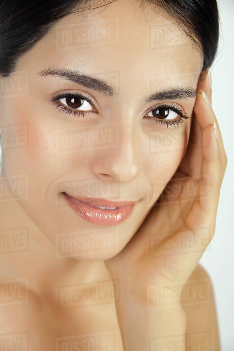 Woman touching face, portrait - Royalty-free Stock Photo | Dissolve