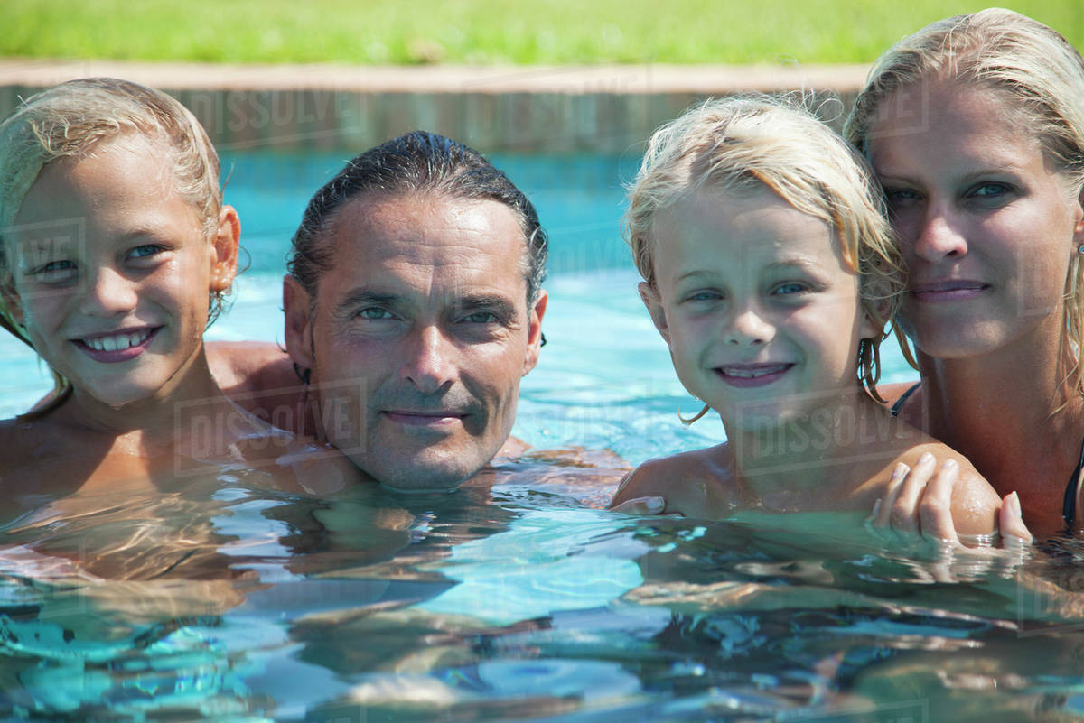Family in swimming pool, portrait - Royalty-free Stock Photo | Dissolve