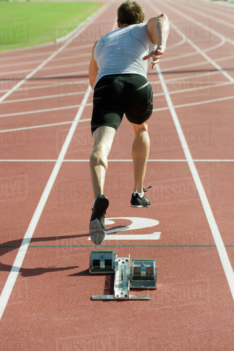 Runner at starting line, rear view - Stock Photo - Dissolve