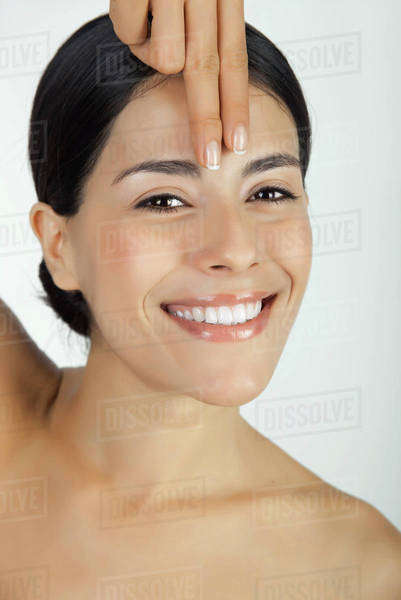 Woman placing fingers on forehead, portrait - Royalty-free Stock Photo ...