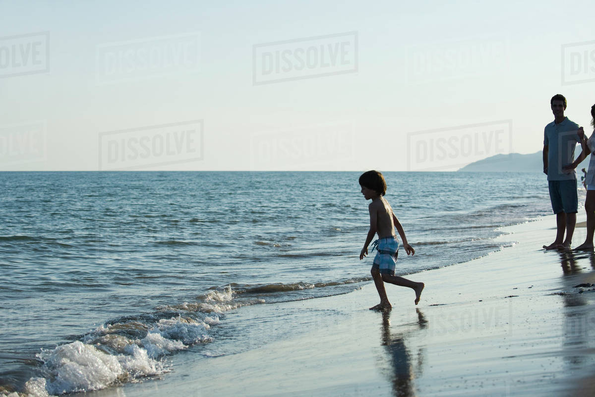 Boy playing at the beach - Royalty-free Stock Photo | Dissolve