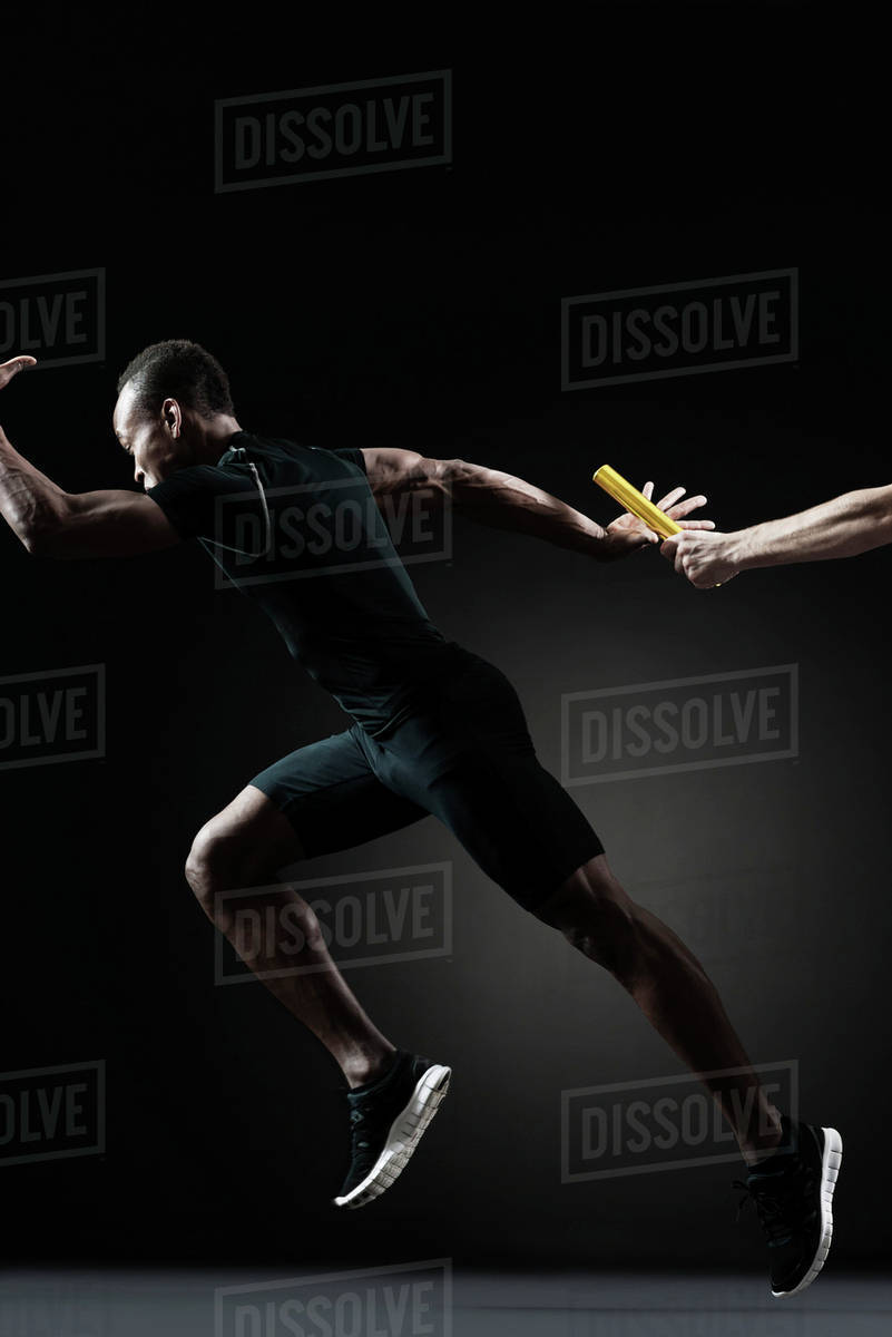 Runners passing baton - Royalty-free Stock Photo | Dissolve