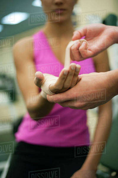 Person wrapping bandage around woman's hand, cropped - Royalty-free ...