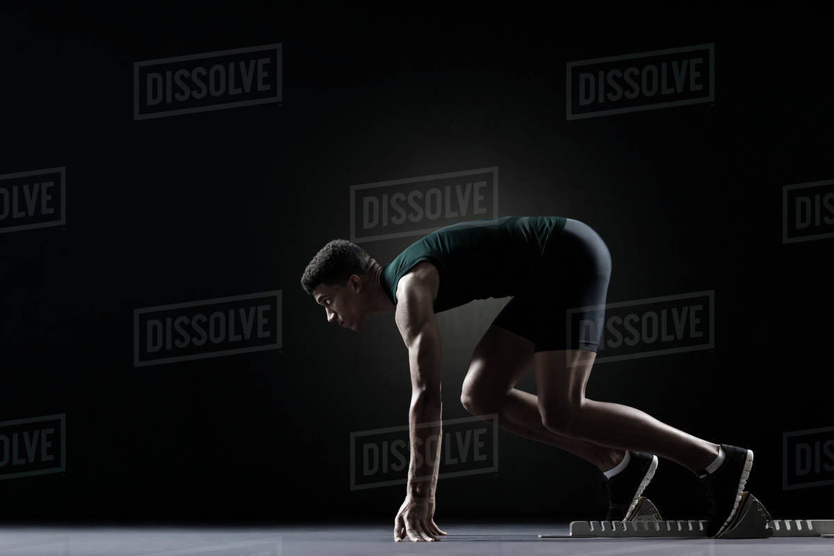 Runner on starting block - Stock Photo - Dissolve