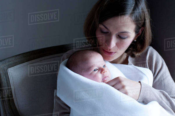 Woman holding newborn baby - Royalty-free Stock Photo | Dissolve