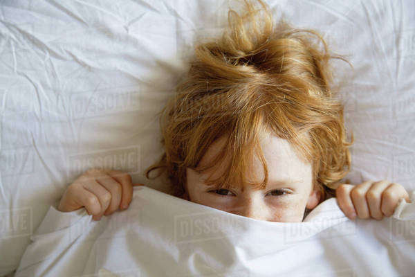 Boy covering face with bed sheet, directly above - Royalty-free Stock ...