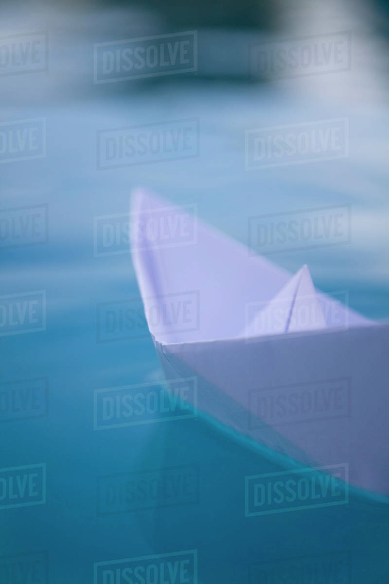 Paper boat floating on water - Royalty-free Stock Photo | Dissolve
