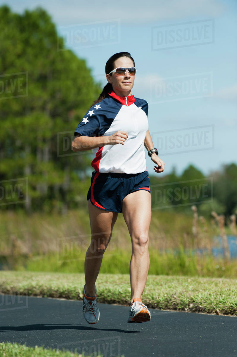 Woman running, portrait - Royalty-free Stock Photo | Dissolve