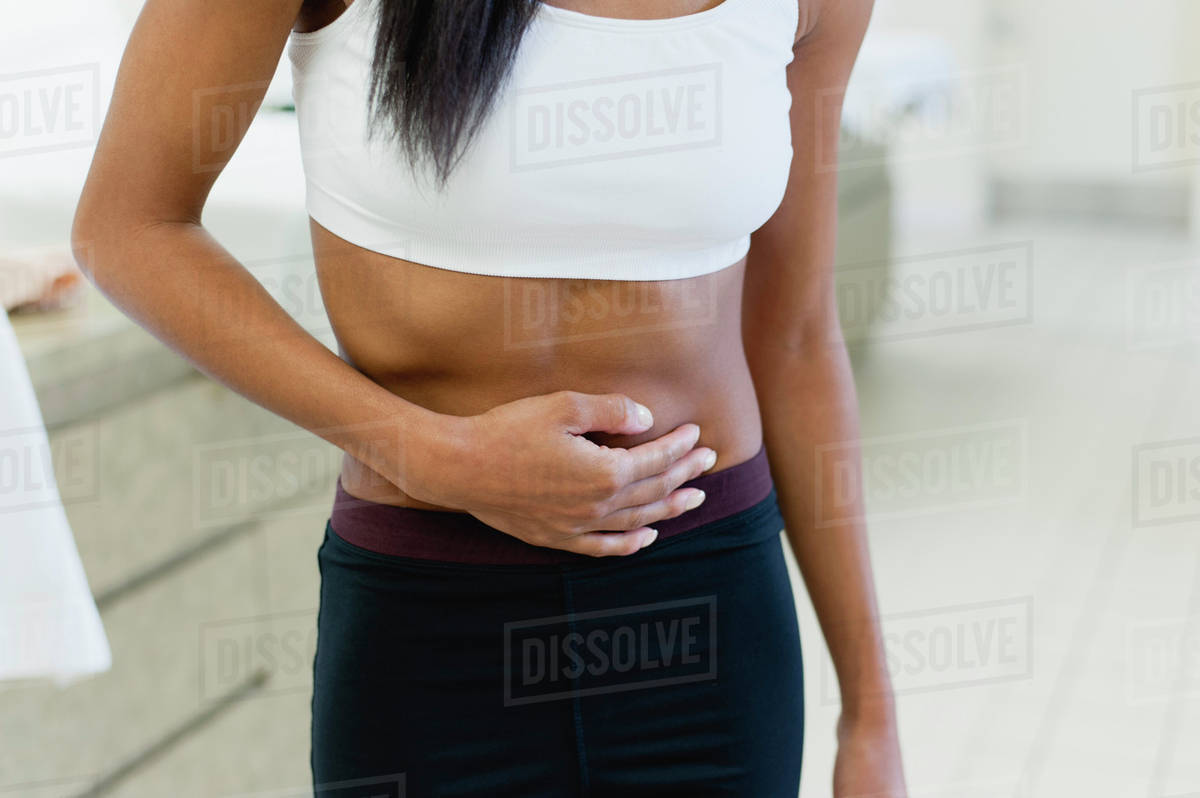 Woman experiencing abdominal pain, mid section - Royalty-free Stock ...