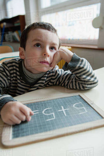 Boy solving math problem - Royalty-free Stock Photo | Dissolve