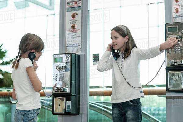 Children using payphones - Royalty-free Stock Photo | Dissolve