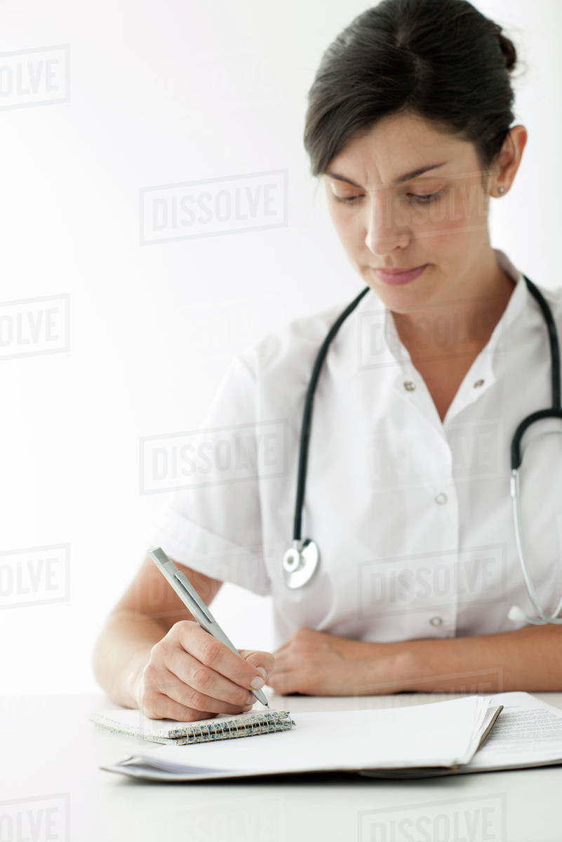 Doctor writing notes - Royalty-free Stock Photo | Dissolve