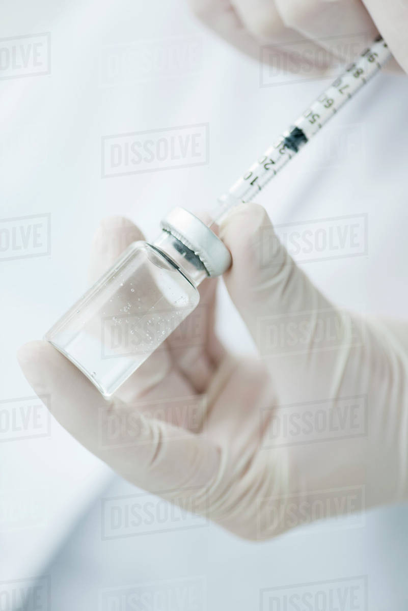 Extracting liquid from vial with syringe - Royalty-free Stock Photo ...