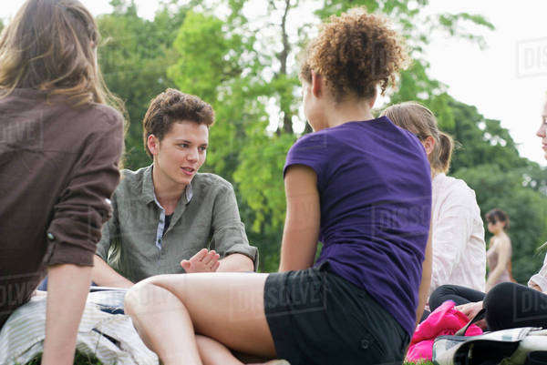 Young adult friends hanging out together outdoors - Royalty-free Stock ...