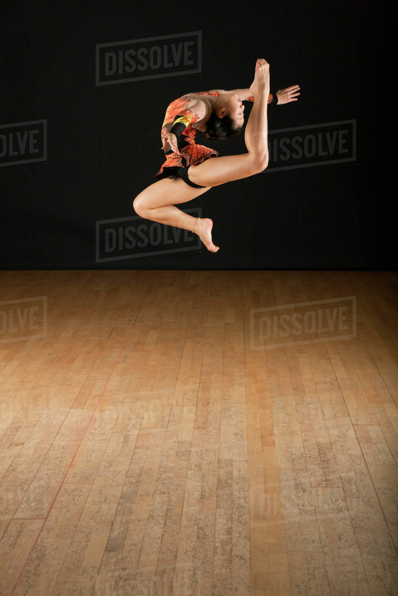Gymnast jumping in air - Royalty-free Stock Photo | Dissolve
