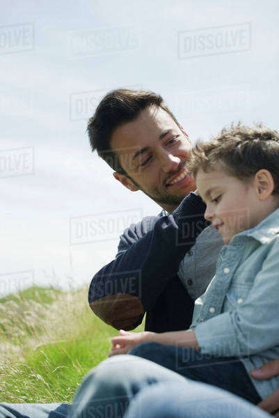 Father caressing son's hair outdoors - Royalty-free Stock Photo | Dissolve