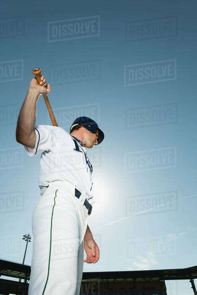 Baseball player holding baseball bat across shoulders - Royalty-free ...