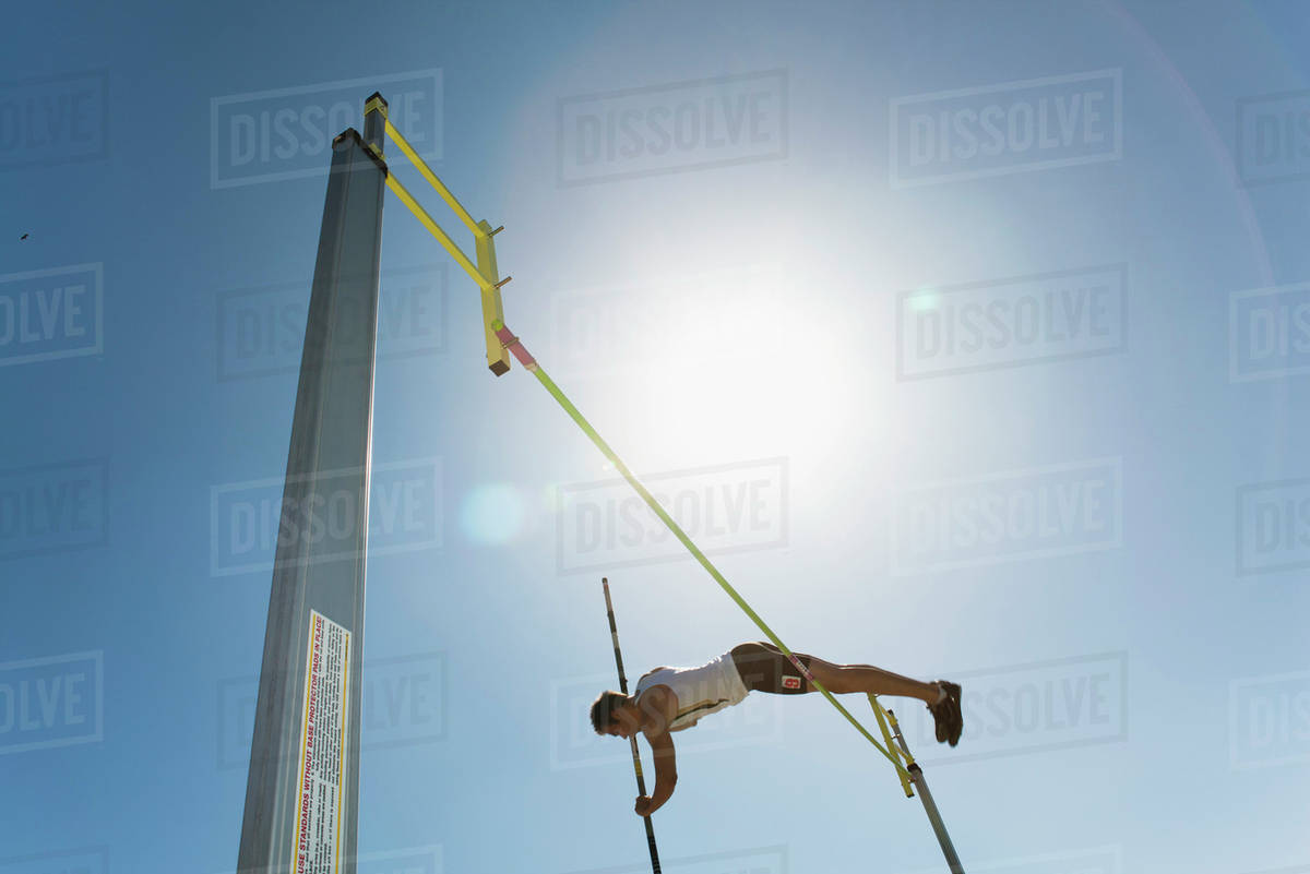 Male athlete jumping over high jump bar - Royalty-free Stock Photo ...