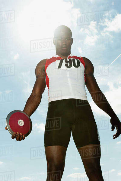 Male athlete holding discus, low angle view - Royalty-free Stock Photo ...