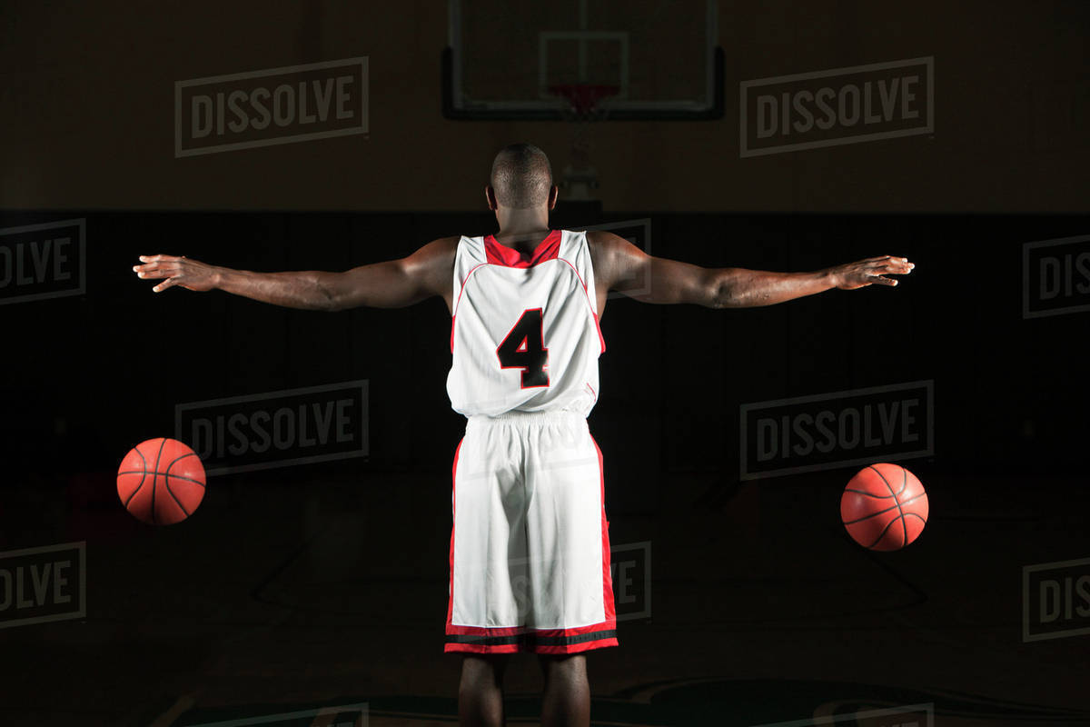 Basketball player dribbling two balls - Royalty-free Stock Photo | Dissolve