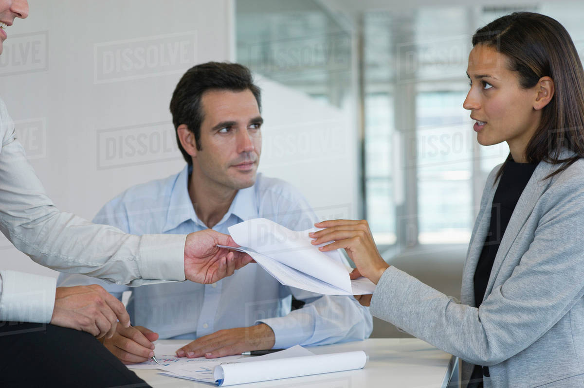 Colleagues discussing documents in meeting - Royalty-free Stock Photo ...