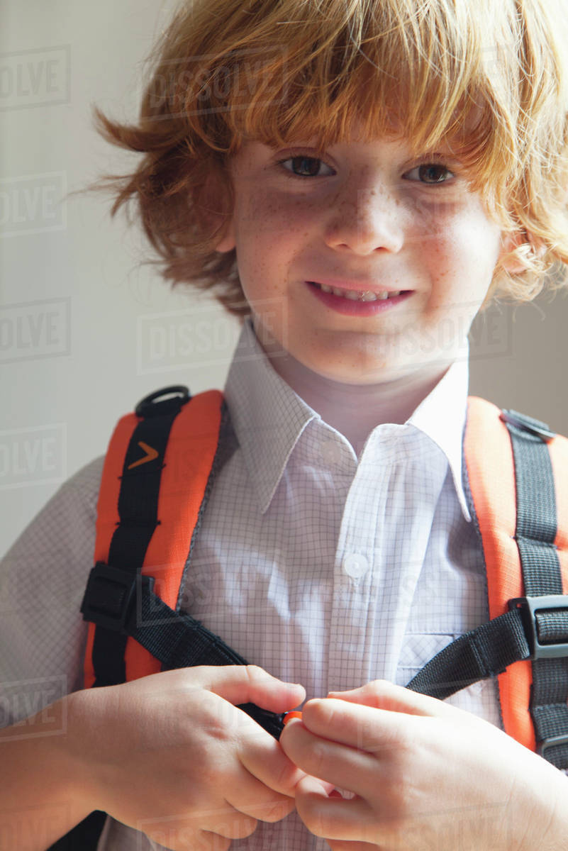 Boy wearing backpack, portrait - Royalty-free Stock Photo | Dissolve
