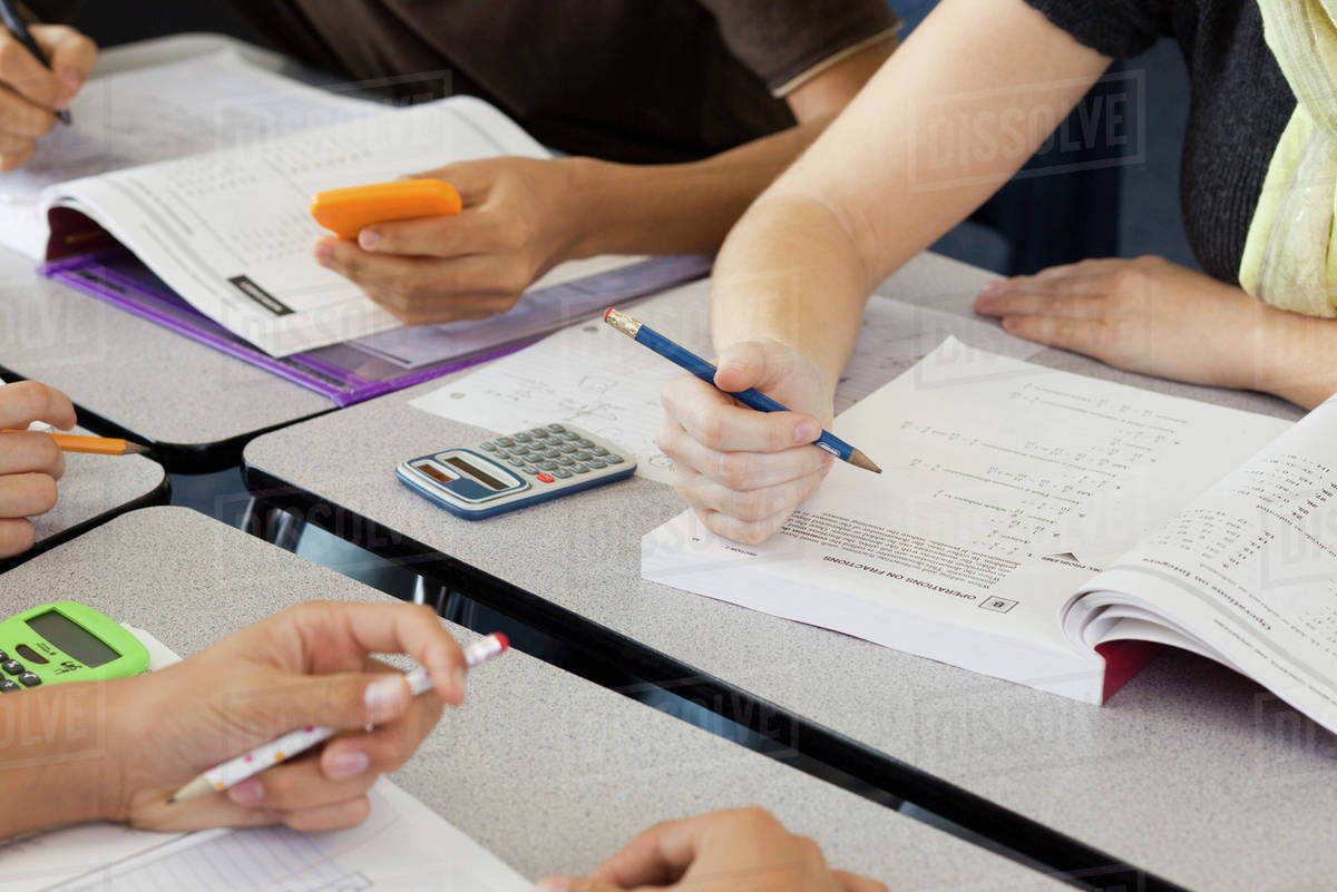 Students completing mathematics assignment together, cropped - Stock ...
