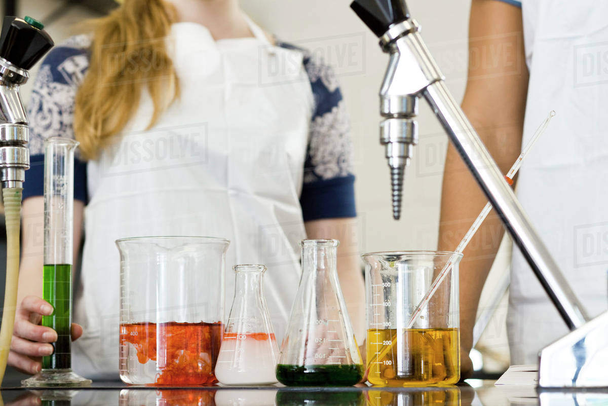 Students conducting experiment in chemistry class, cropped - Royalty ...