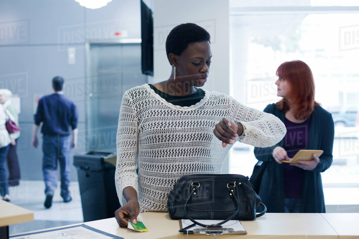Female customer checking time while waiting - Royalty-free Stock Photo ...