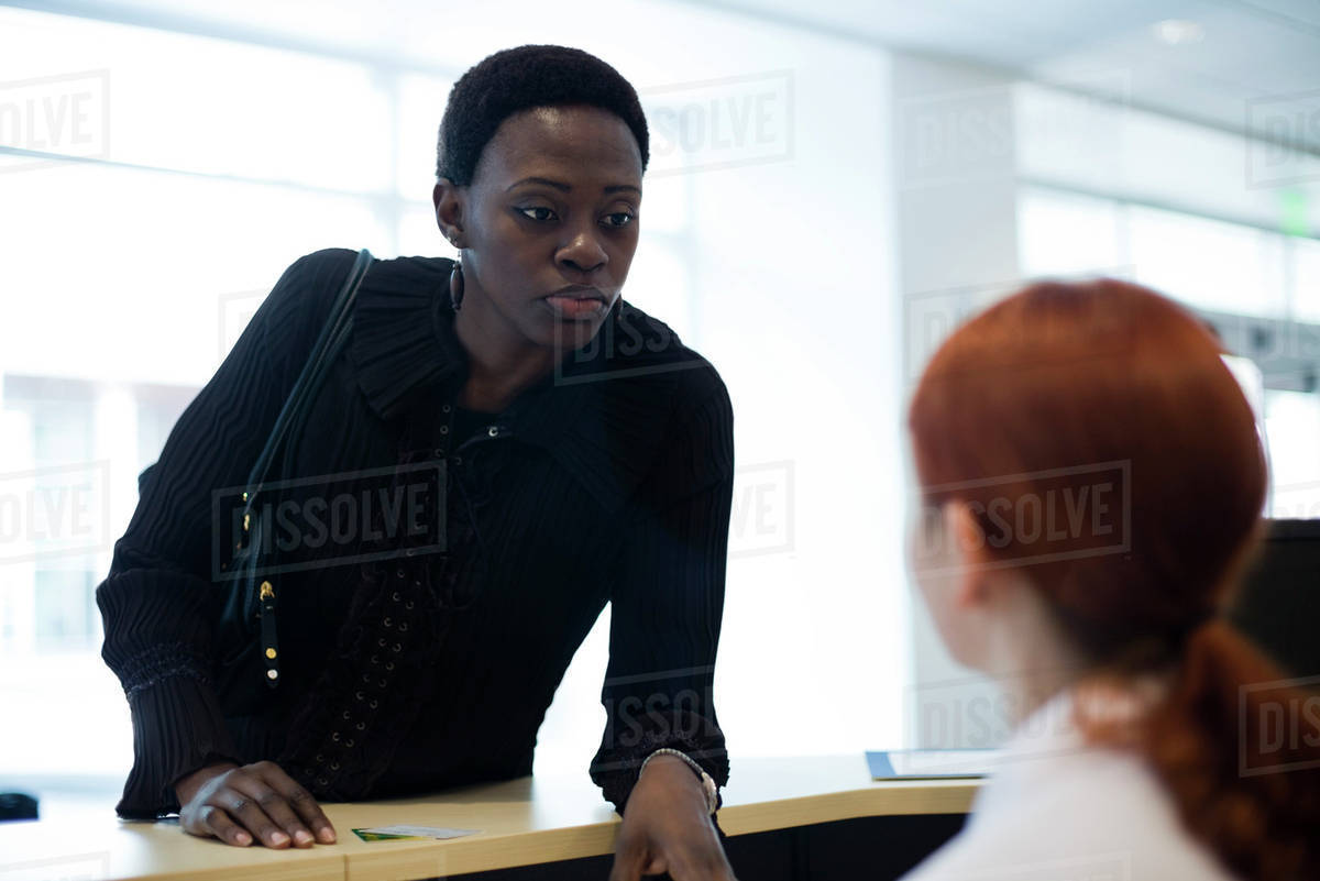 Upset customer talking to receptionist - Royalty-free Stock Photo ...