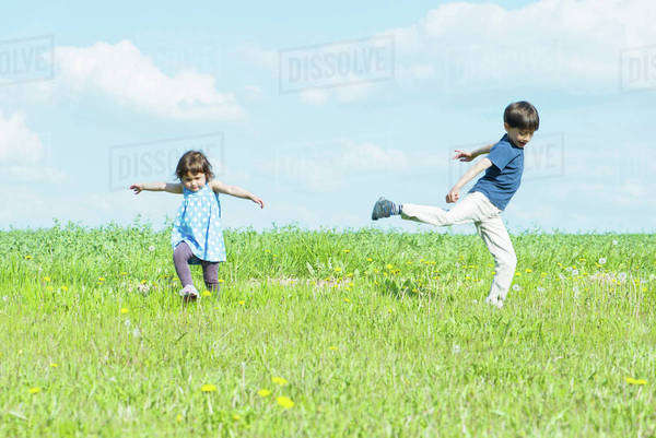 Children running in field with arms out - Royalty-free Stock Photo ...